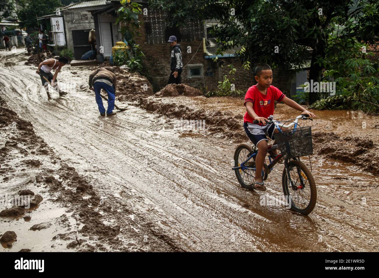 Sumedang, Indonesia. 10th Jan, 2021. A child seen cycling through a ...