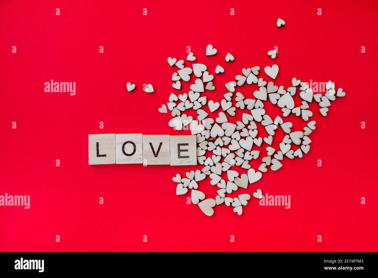 love inscription made of wooden square letters on bright red background ...