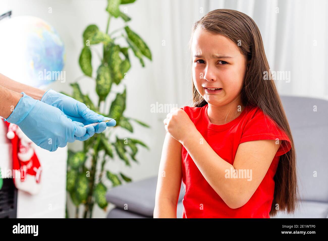 Doctor holds syringe to vaccinate sick baby with injection. Crying and ...