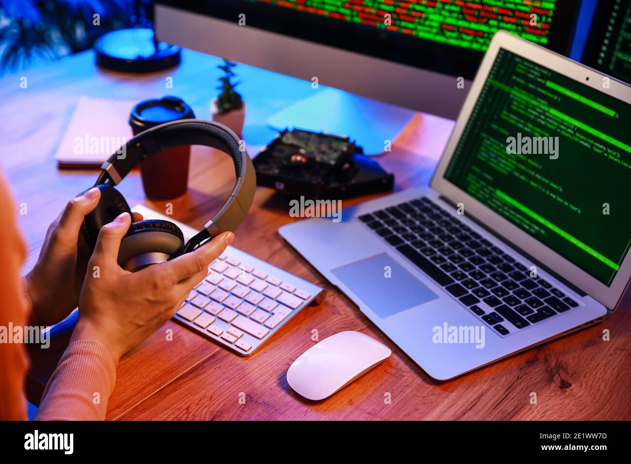 Female programmer with headphones in office Stock Photo - Alamy