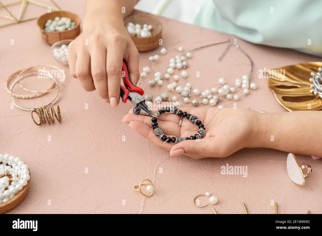 Female designer making jewelry at workplace Stock Photo - Alamy
