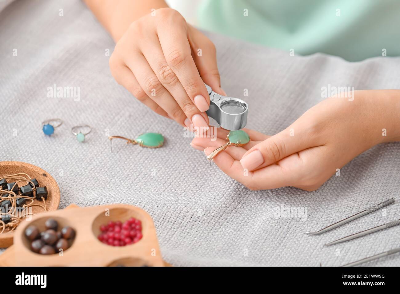 Female designer making jewelry at workplace Stock Photo - Alamy