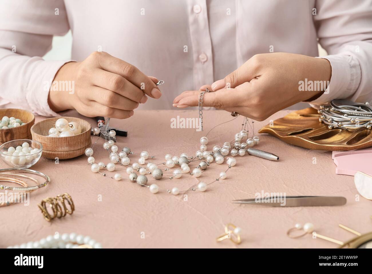 Female designer making jewelry at workplace Stock Photo - Alamy