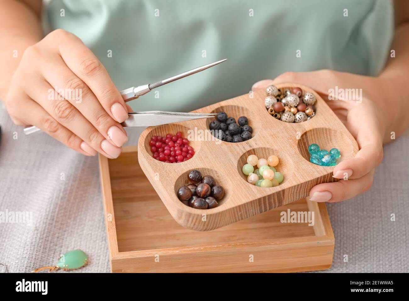 Female designer making jewelry at workplace Stock Photo - Alamy