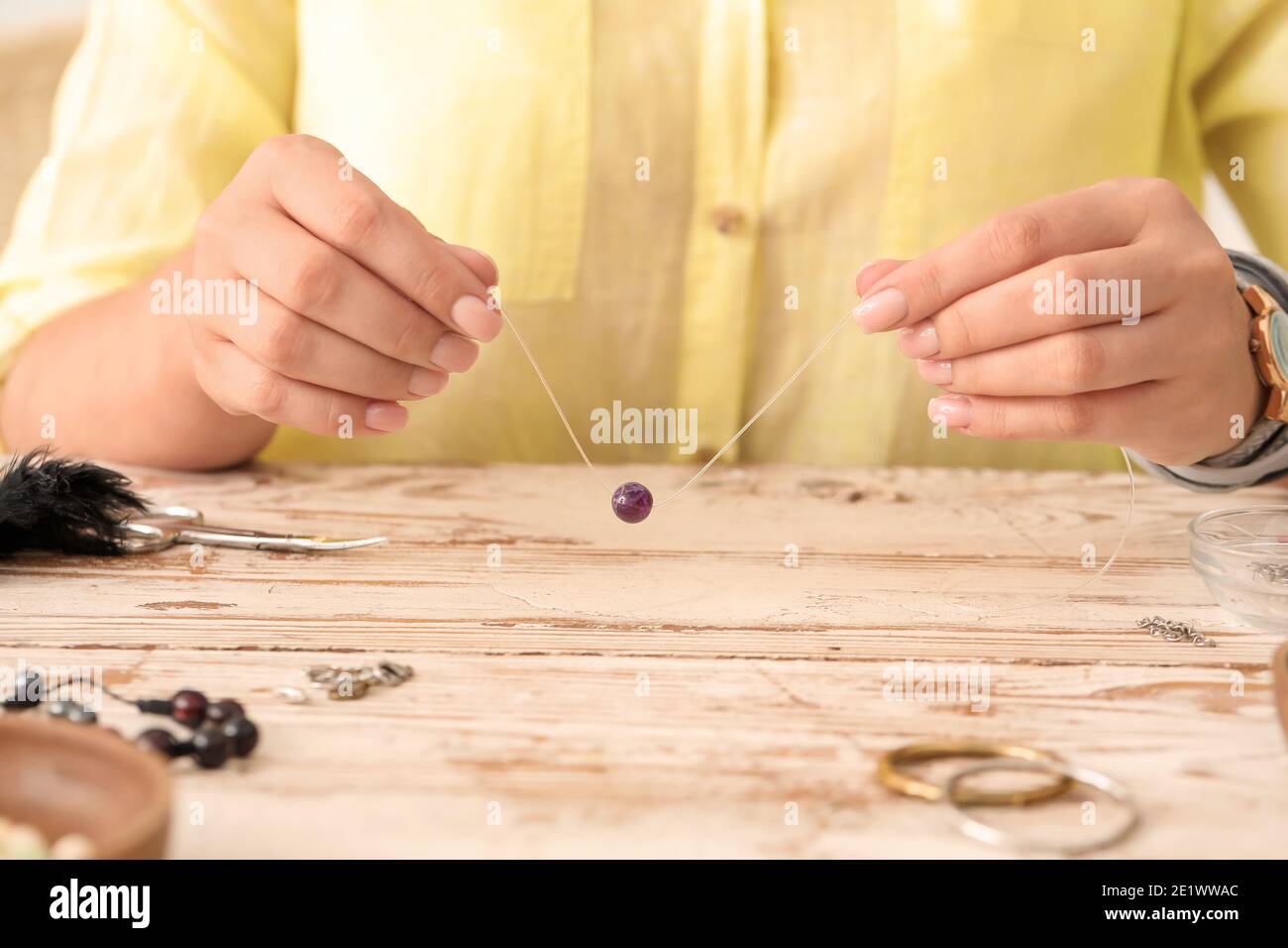 Female designer making jewelry at workplace Stock Photo - Alamy