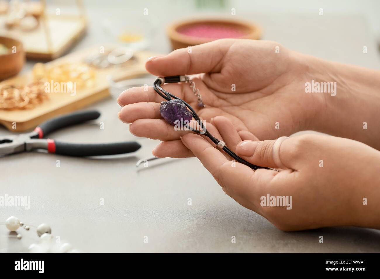 Female designer making jewelry at workplace Stock Photo - Alamy