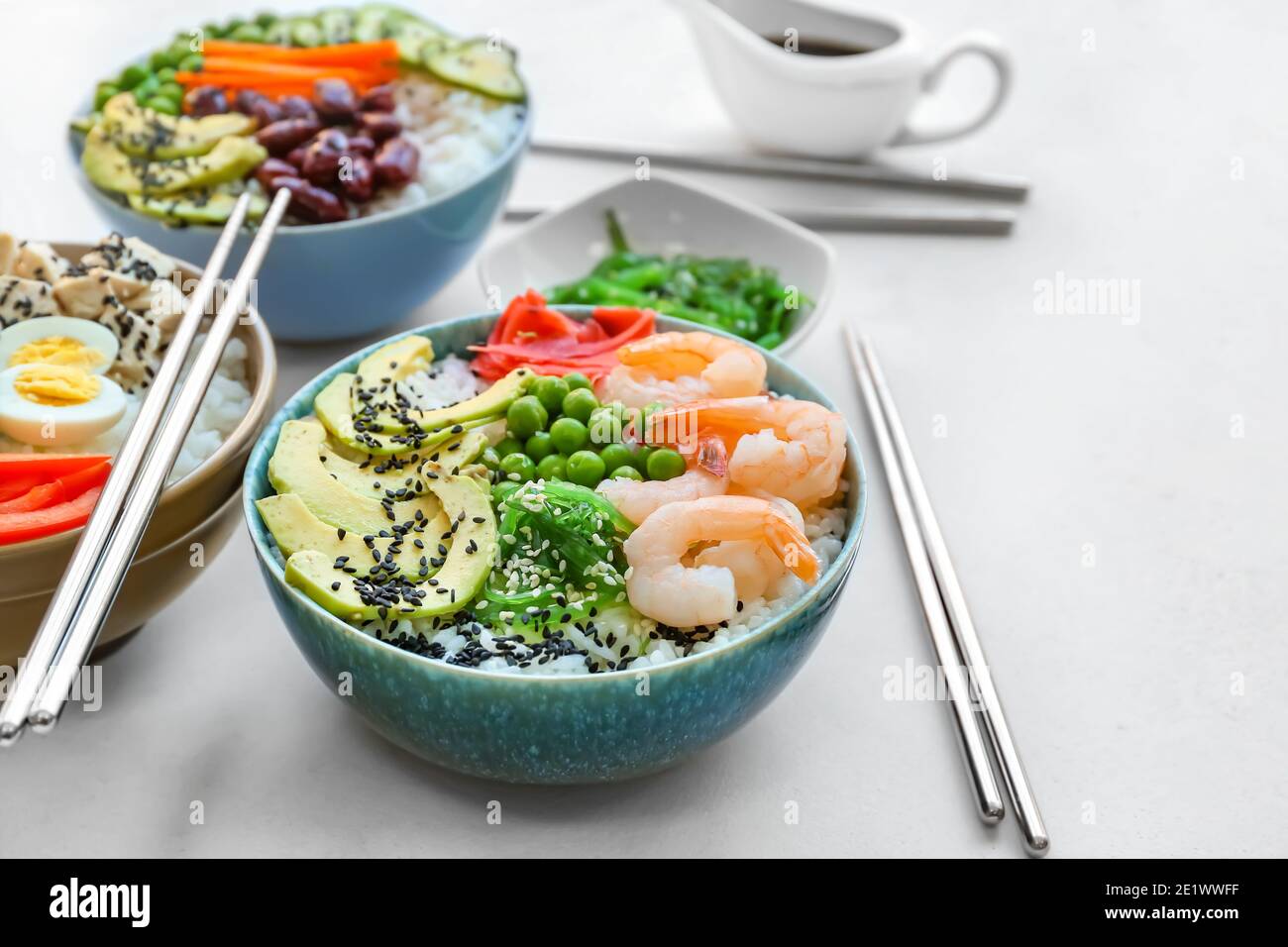 Different poke bowls on light background Stock Photo - Alamy