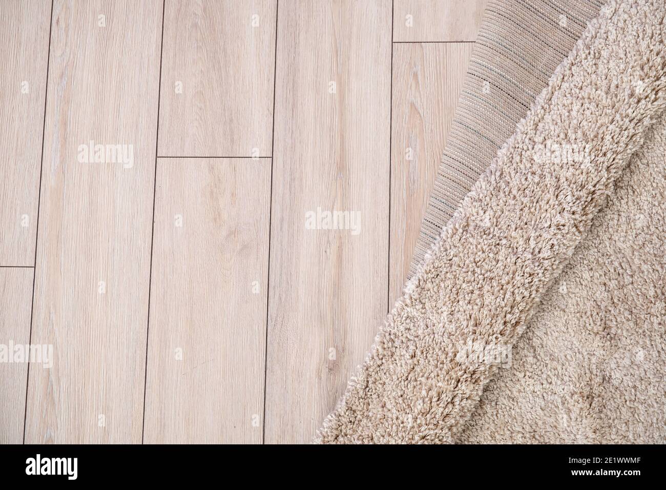Beautiful soft carpet on wooden floor Stock Photo - Alamy
