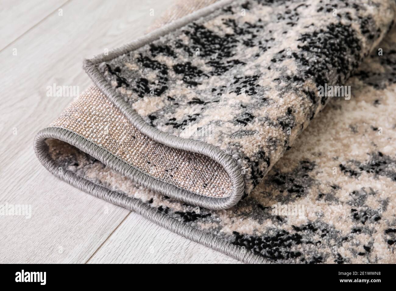 Beautiful soft carpet on wooden floor, closeup Stock Photo - Alamy