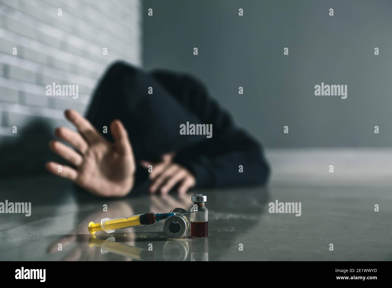 Female junkie making a reach for drugs on floor Stock Photo - Alamy