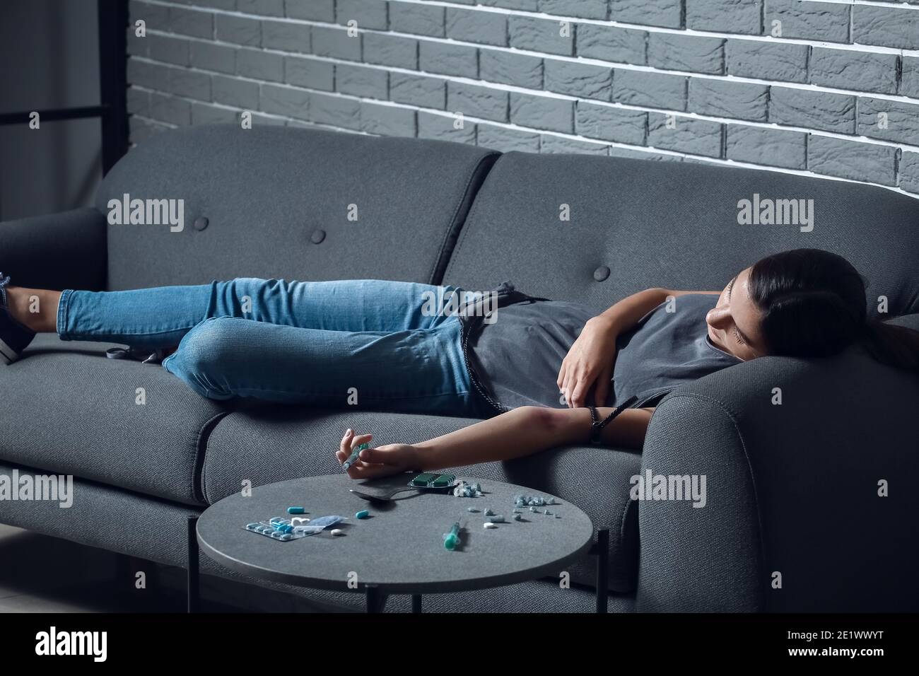 Female junkie lying on sofa at home Stock Photo - Alamy