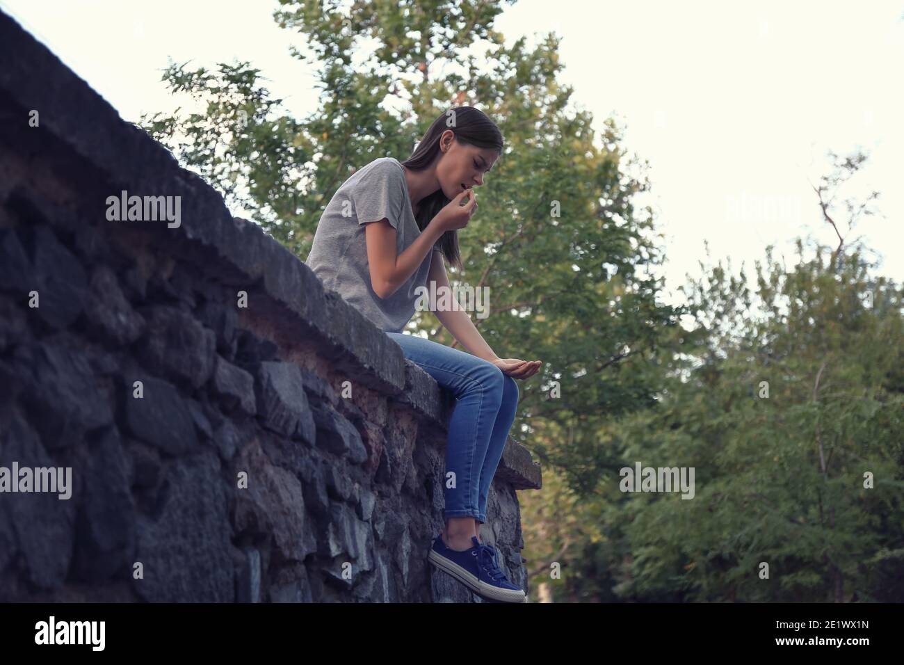 Female junkie taking drugs outdoors Stock Photo - Alamy