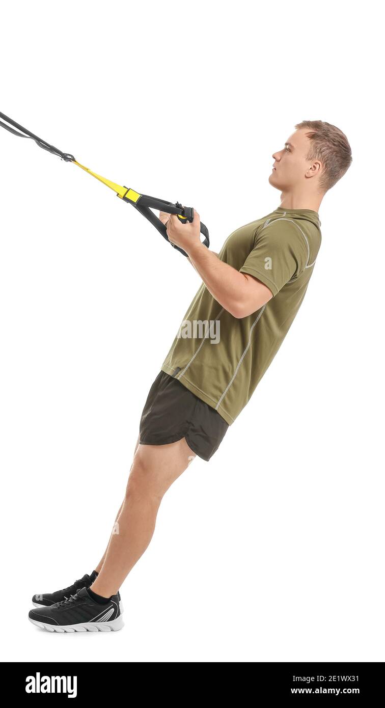 Sporty young man training with TRX straps on white background Stock ...