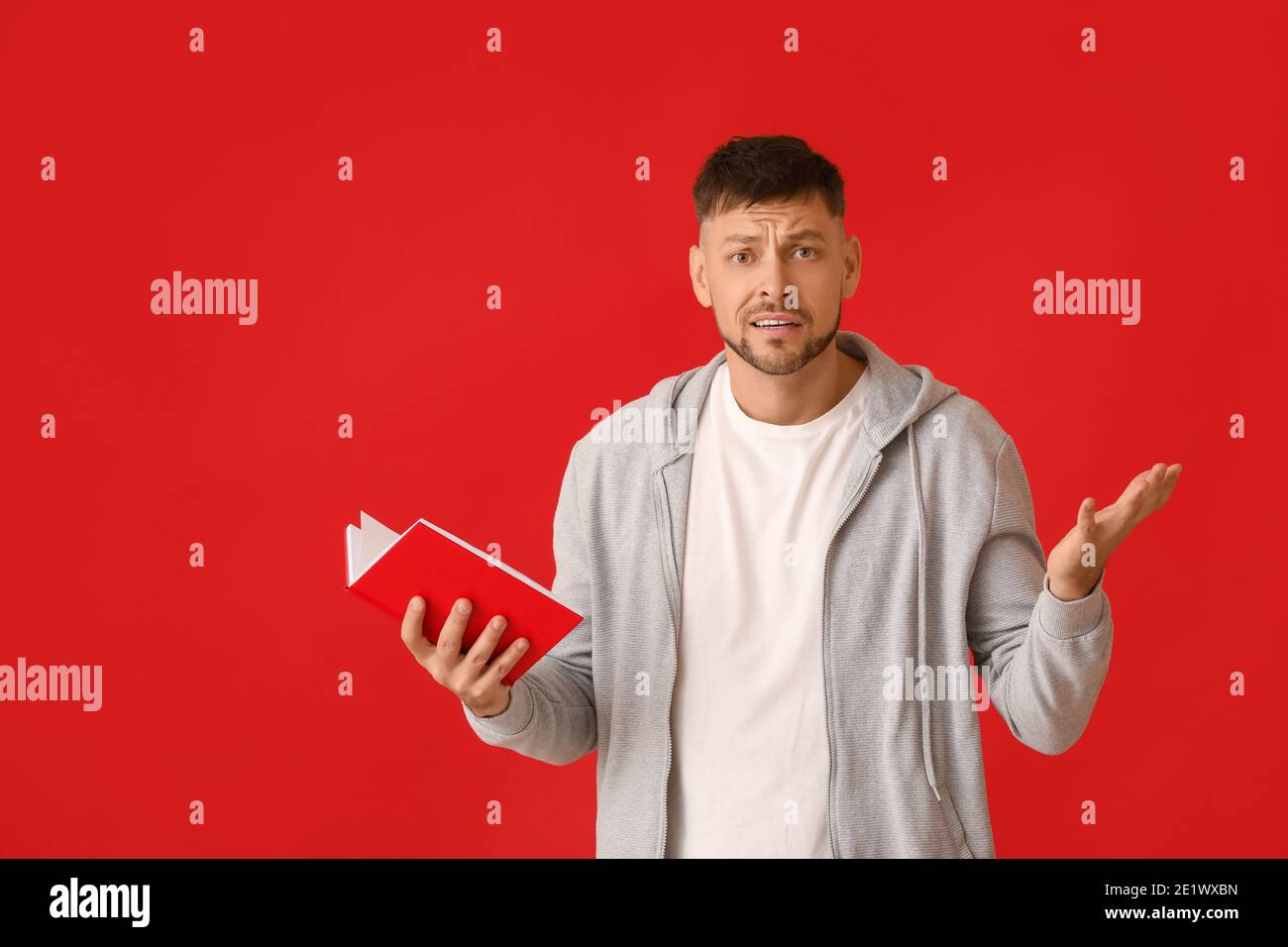 Confused man reading book hi-res stock photography and images - Alamy