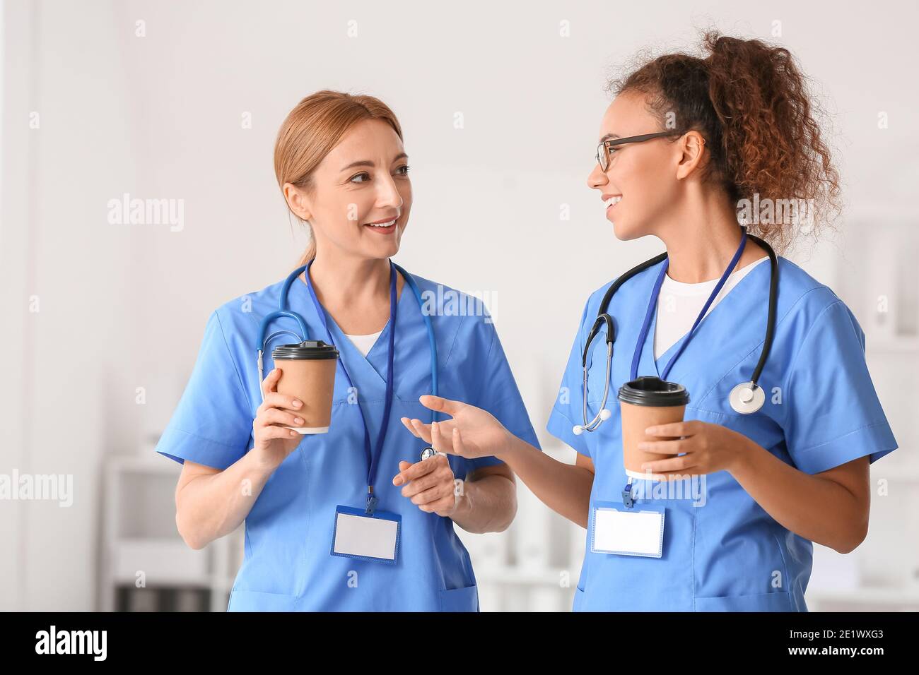 Female doctors drinking coffee in clinic Stock Photo - Alamy