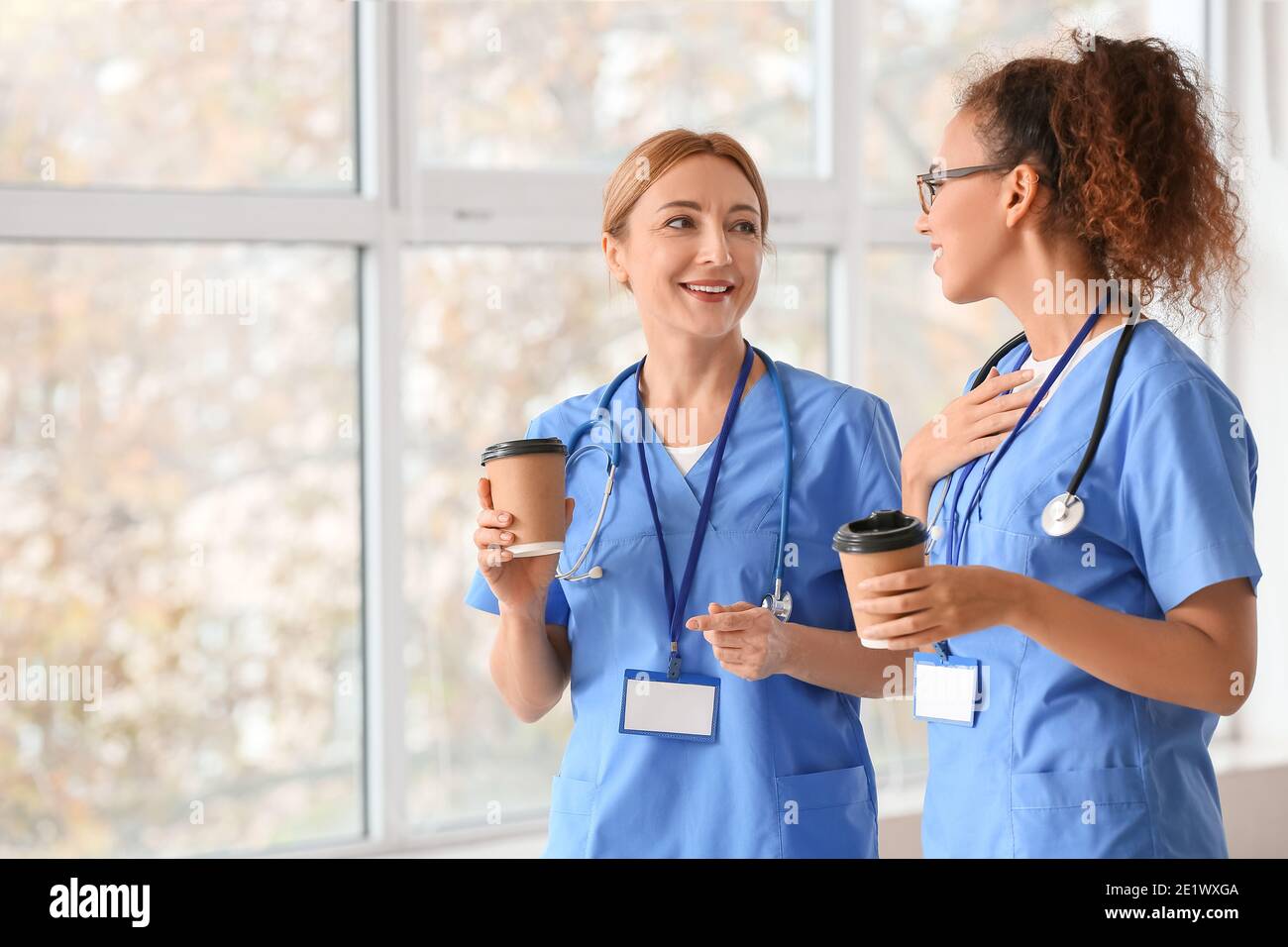 Female doctors drinking coffee in clinic Stock Photo - Alamy