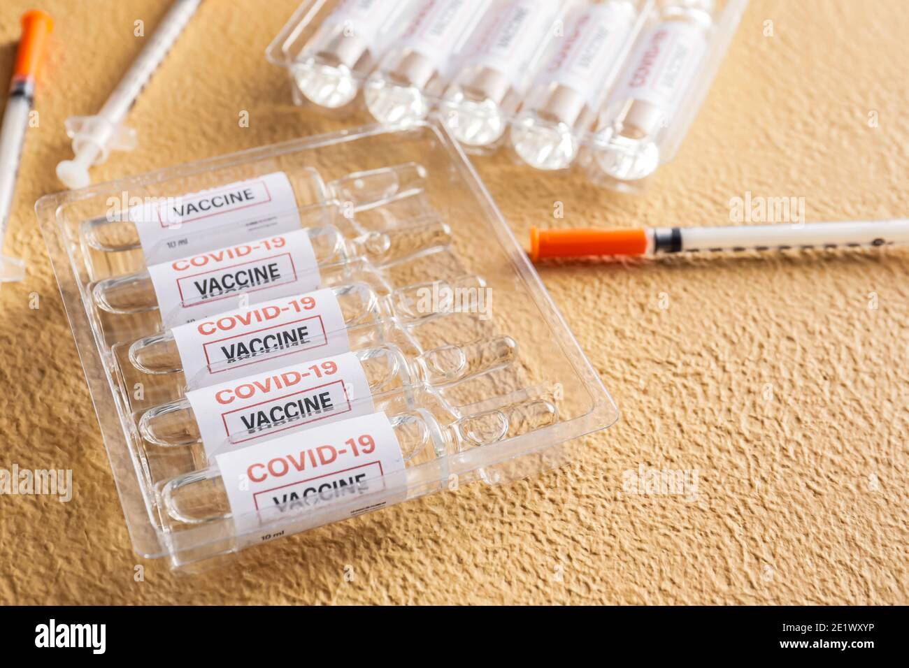 Vaccine for immunization against COVID-19 on color background Stock ...