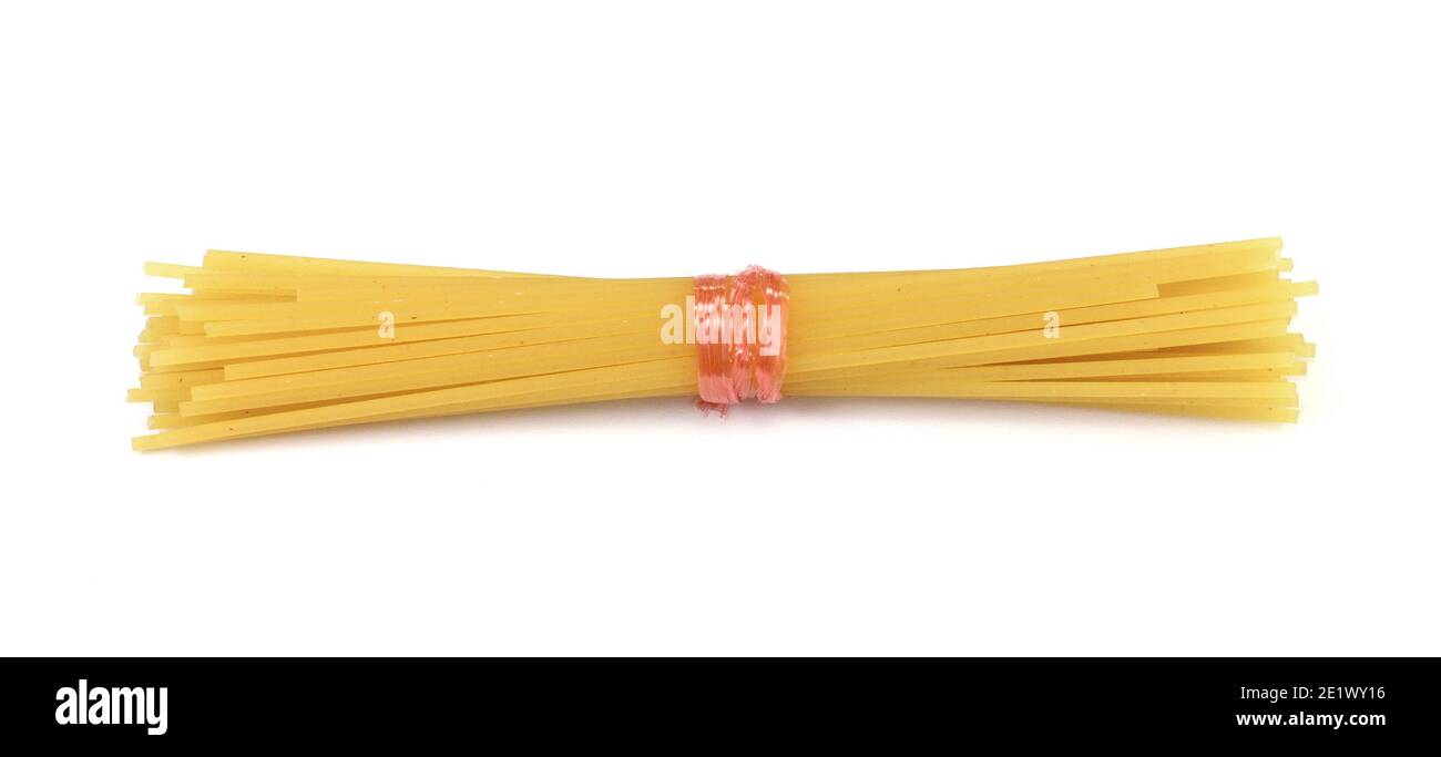 Uncooked dry fettuccine pasta tied in a bundle isolated on a white ...