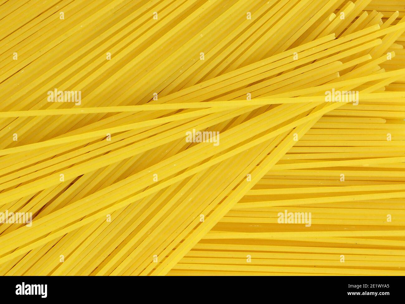 Spaghetti - yellow pasta, ready for cooking. isolated on the white background. uncooked ...