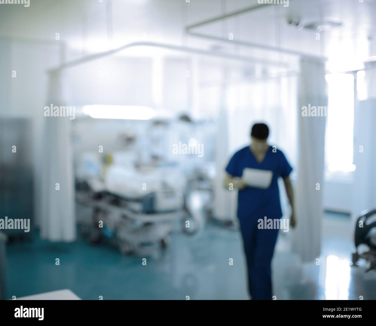 Doctor walking in the ICU, unfocused background Stock Photo - Alamy