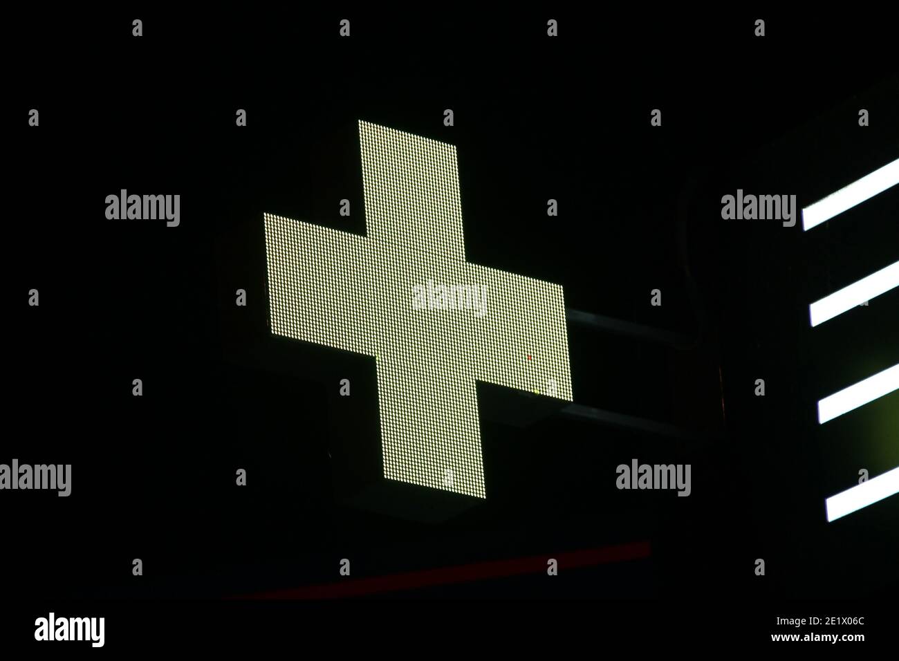 Glowing pixel cross of LED lamps on black background. Green cross ...