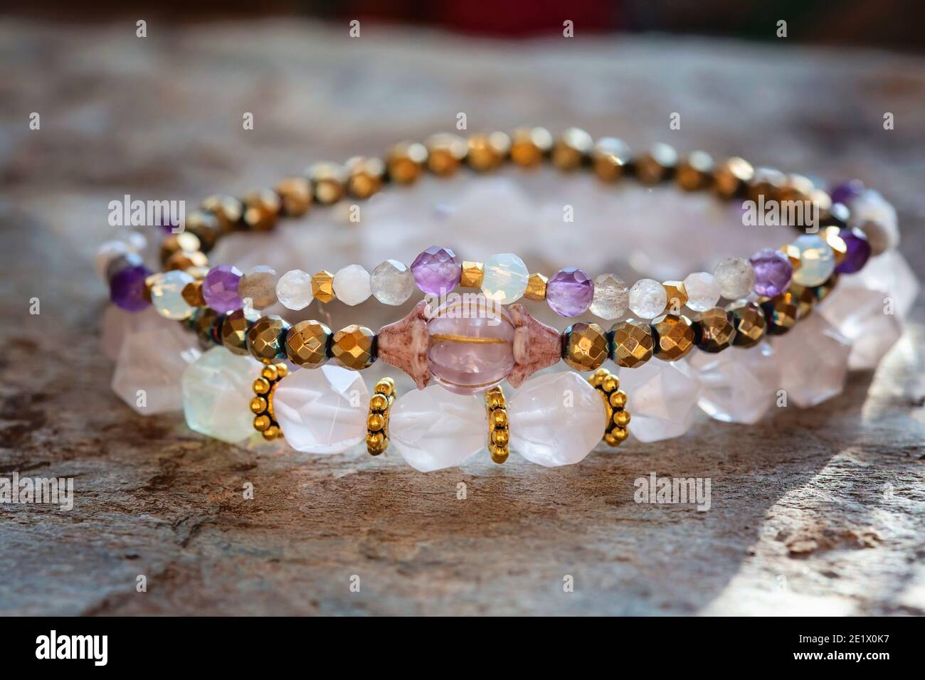 Collection of natural mineral gemstone beads bracletes on natural ...