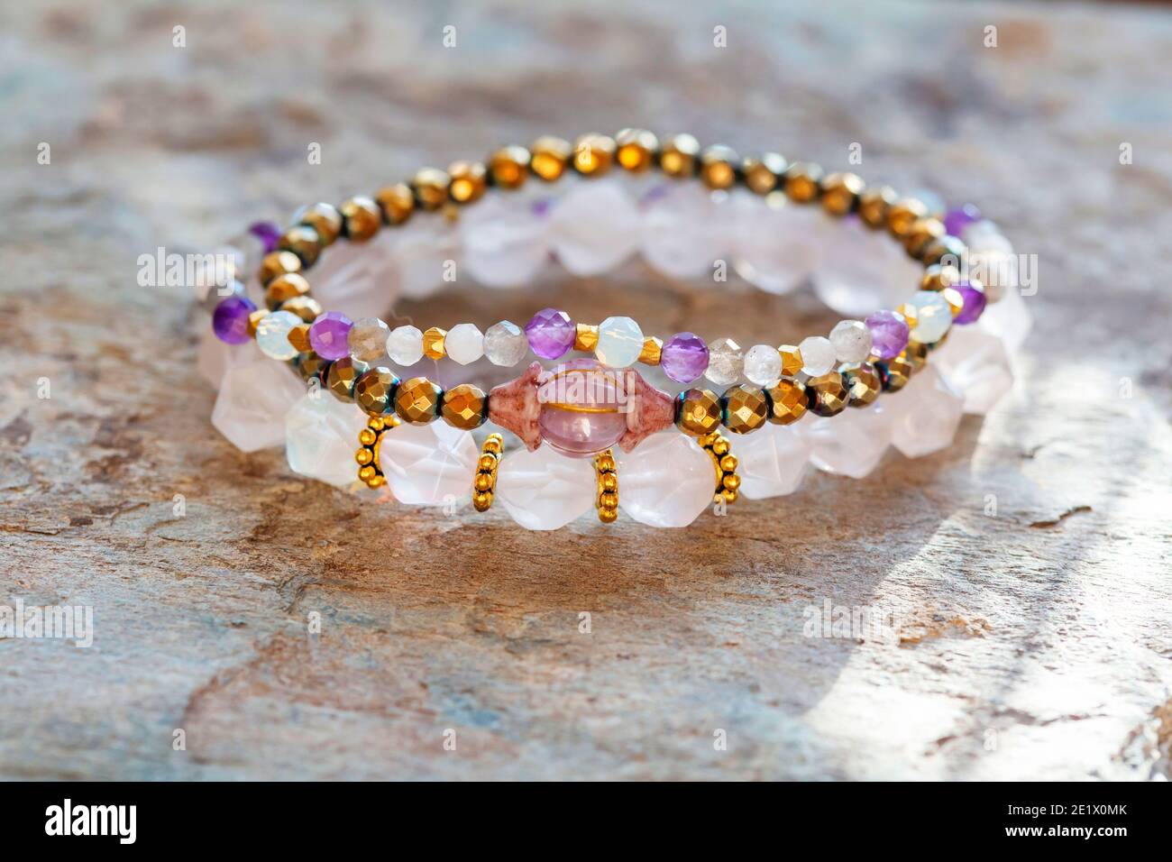 Collection of natural mineral gemstone beads bracletes on natural ...