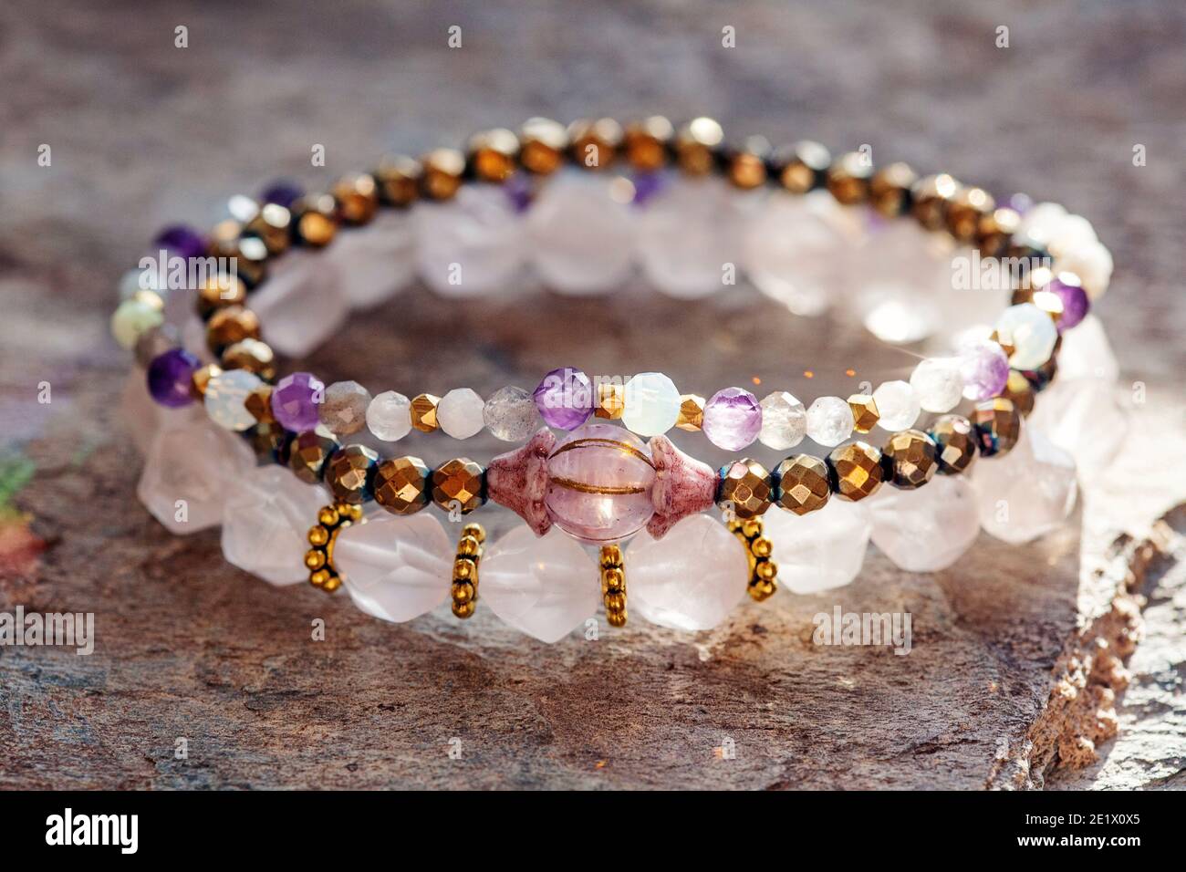 Collection of natural mineral gemstone beads bracletes on natural ...