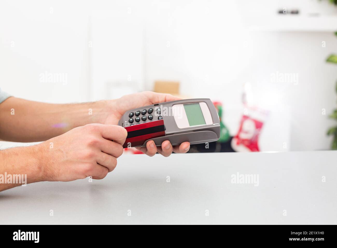 Male hands with credit card into card machine or pos terminal isolated ...