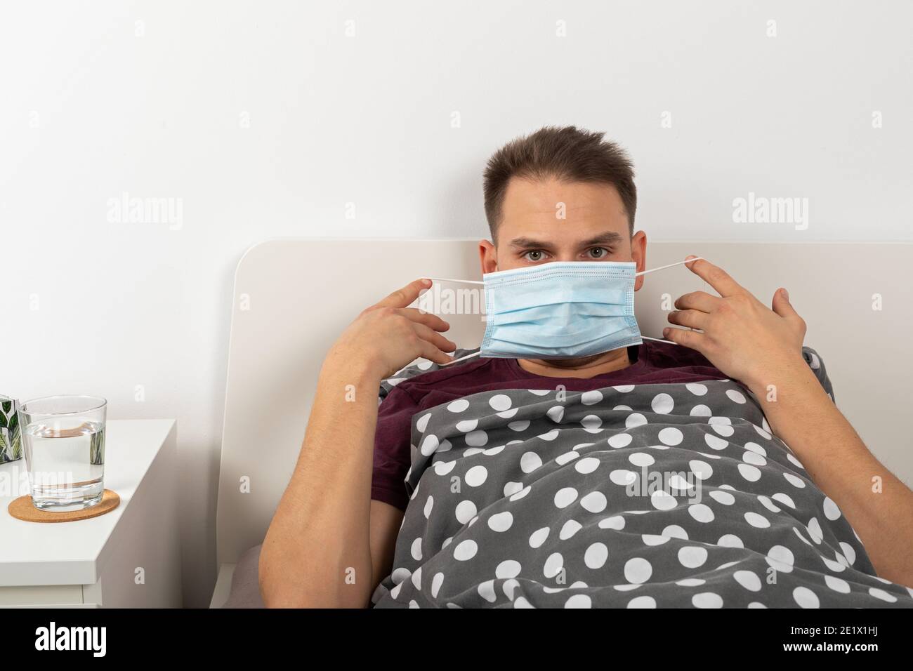 Picture of caucasian young man infected with covid-19 staying in bed at ...