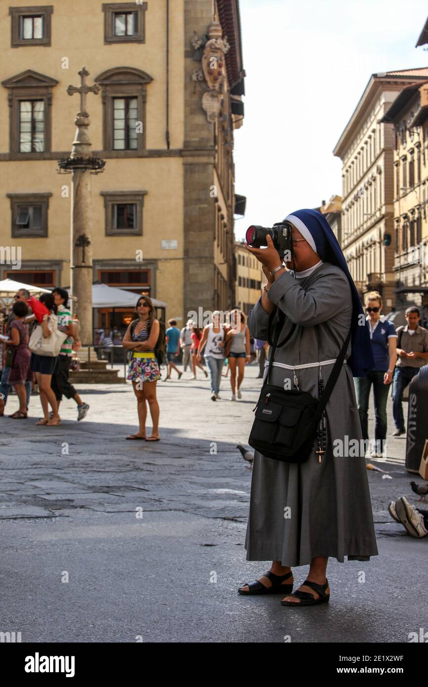 Florence, Italy - September 8, 2001: A nun photographing the sights of ...
