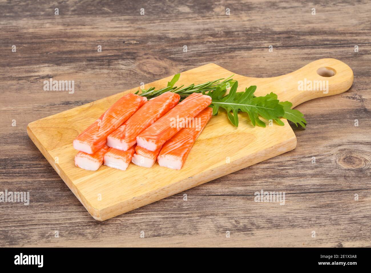 Crab stick surimi over wooden board Stock Photo - Alamy