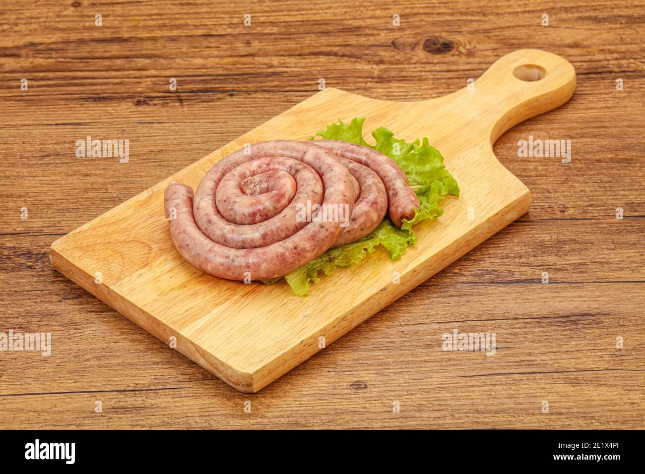 Raw pork sausage ring for grill Stock Photo - Alamy