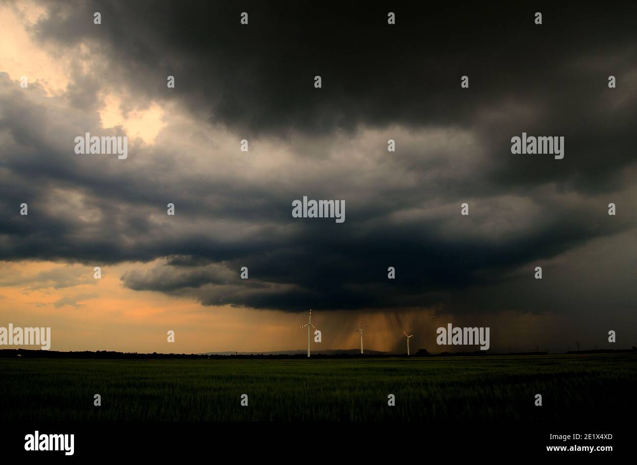 three wind turbines with rain and clouds Stock Photo - Alamy