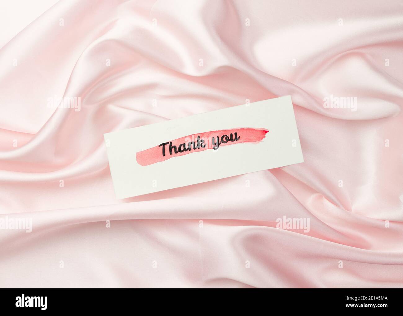 Thank-you note with Thank You inscription on pastel pink silk ...