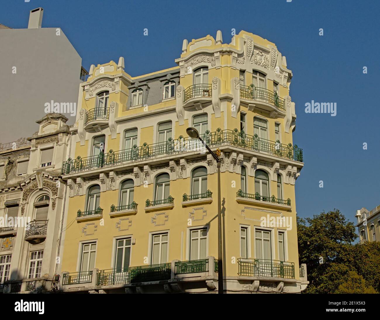Detail of typical portuguese apartment building in yellow pastel color ...