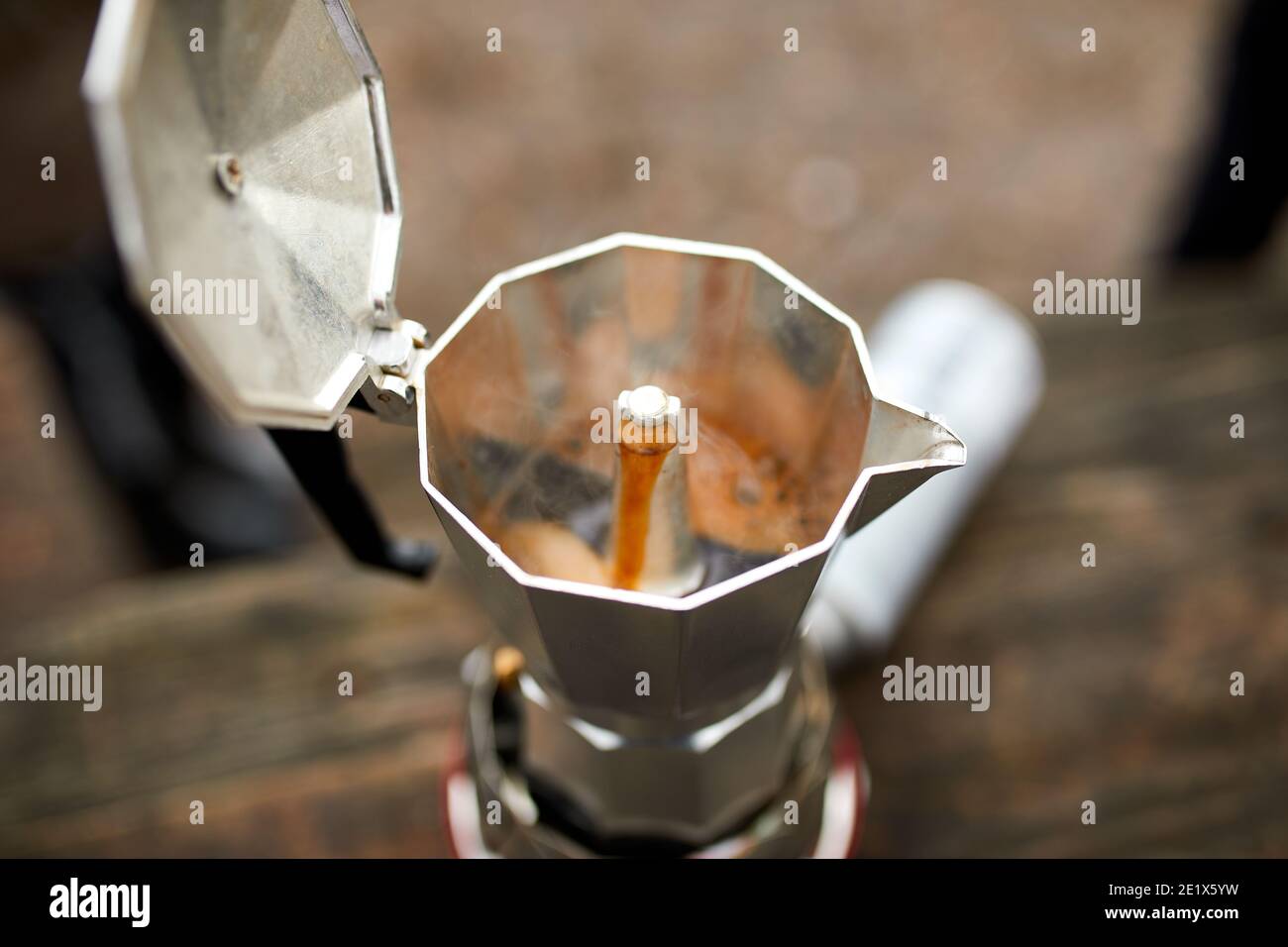 Process of making coffee outdoor with metal geyser coffee maker on a ...
