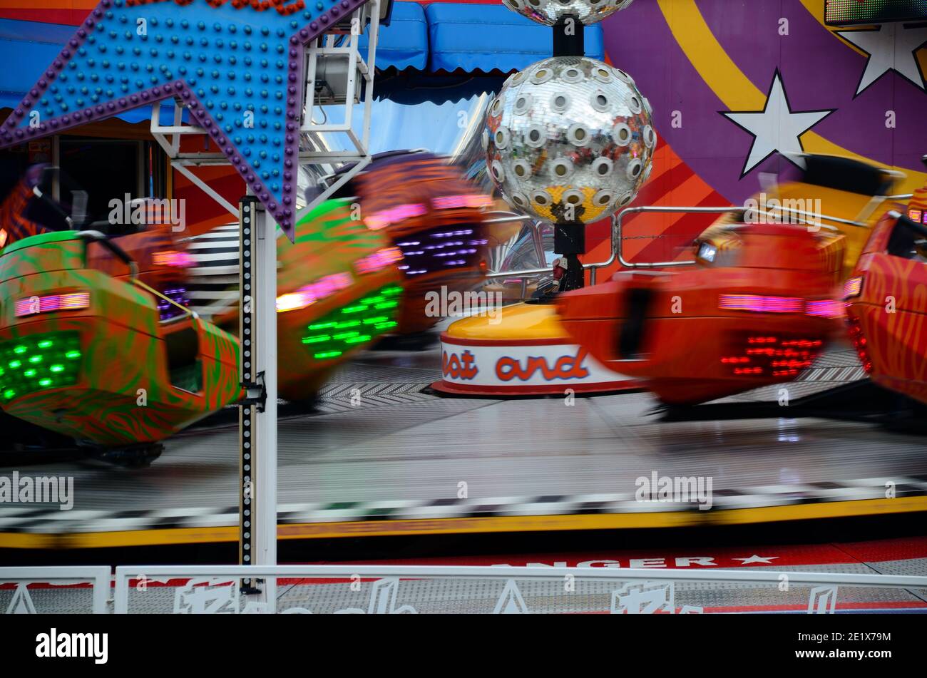 rapidly rotating colorful carousel in an theme park Stock Photo - Alamy