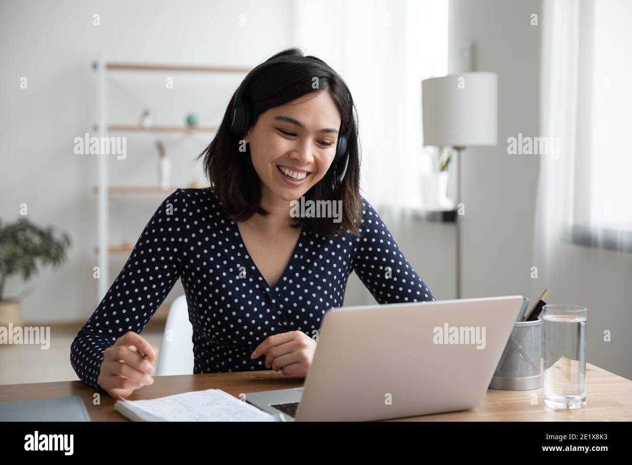 Happy korean woman in headset involved in video call conversation Stock ...
