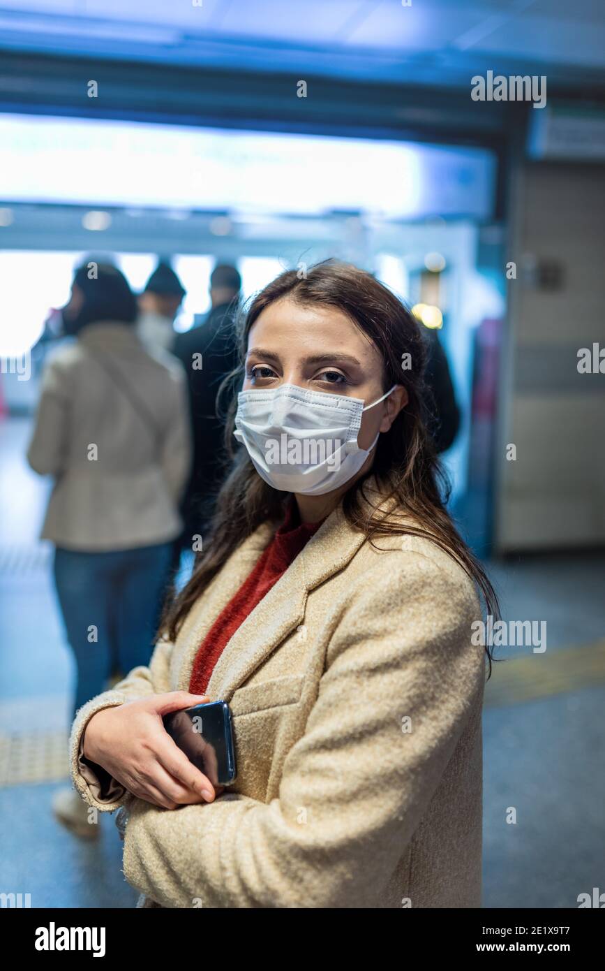 Beautiful woman wearing protective medical mask and fashionable clothes ...