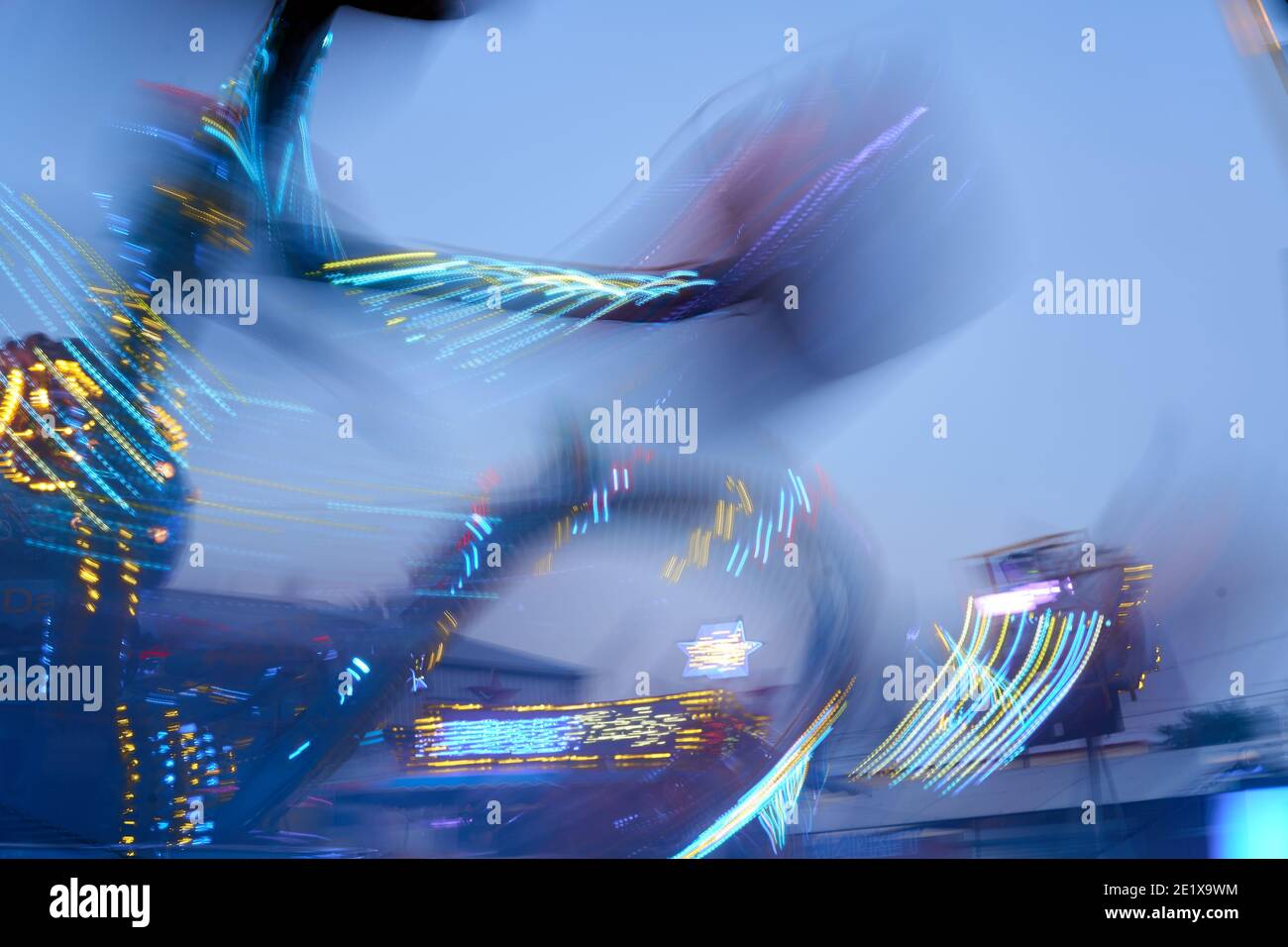 Amusement park blurred effect. Abstract illuminated background Spinning ...