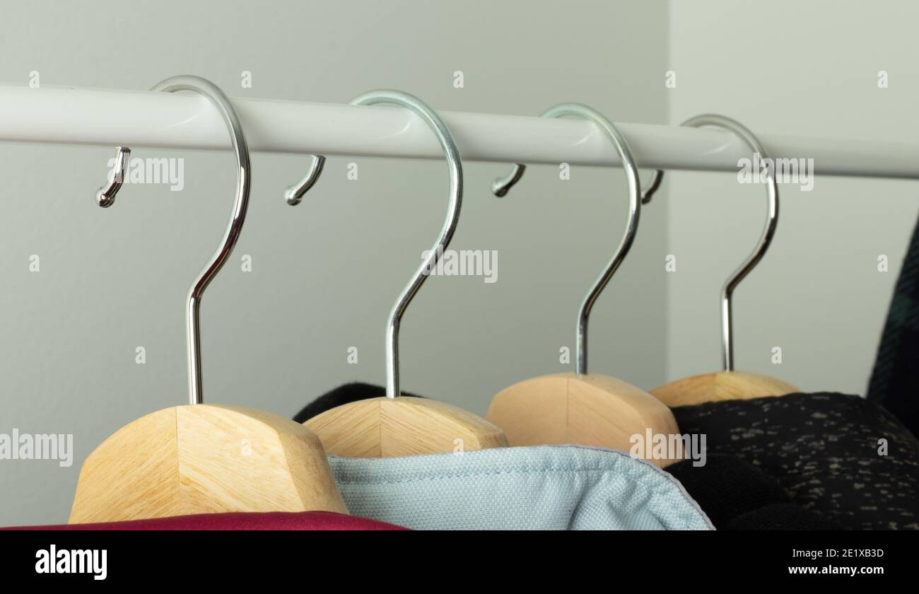 Clothes hangers on the bar in a clothing store. Retail store business ...