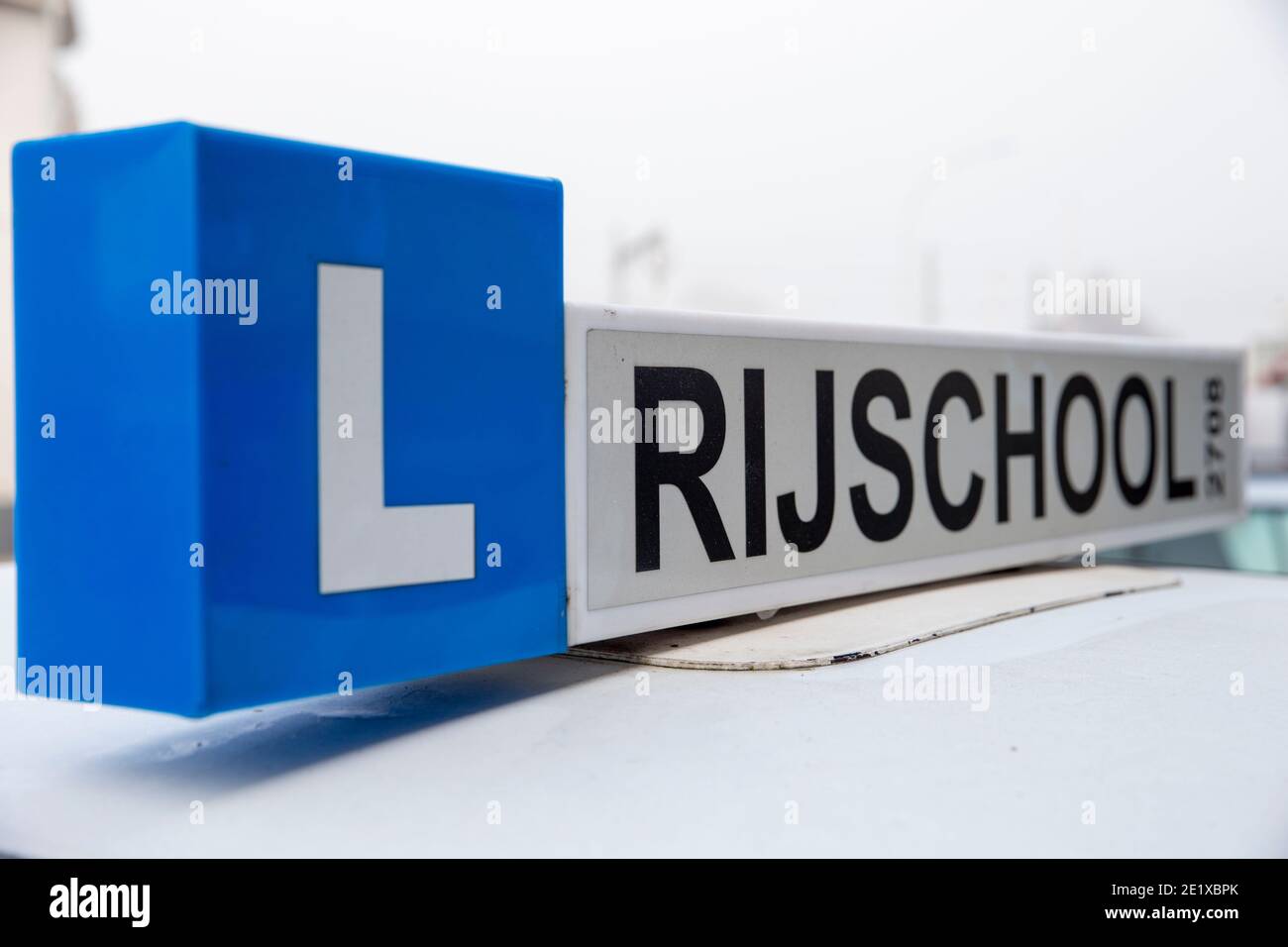 Illustration shows the L letter on a car of a driving school in ...
