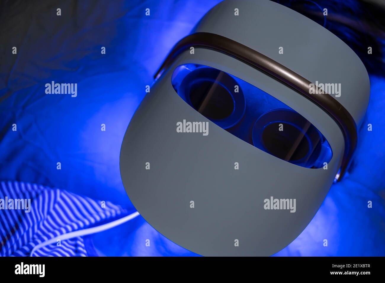 Woman with blue led light therapy facial and neck beauty mask photon ...