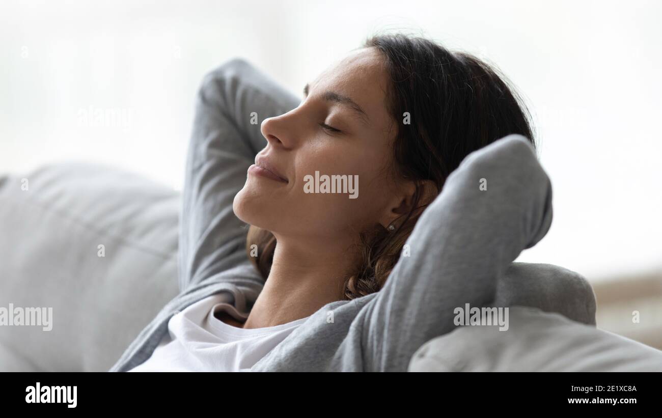 Close up peaceful woman with closed eyes resting on couch Stock Photo ...