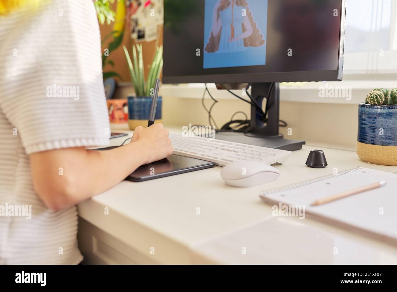 Close-up of young woman's hand drawing on computer using graphics ...