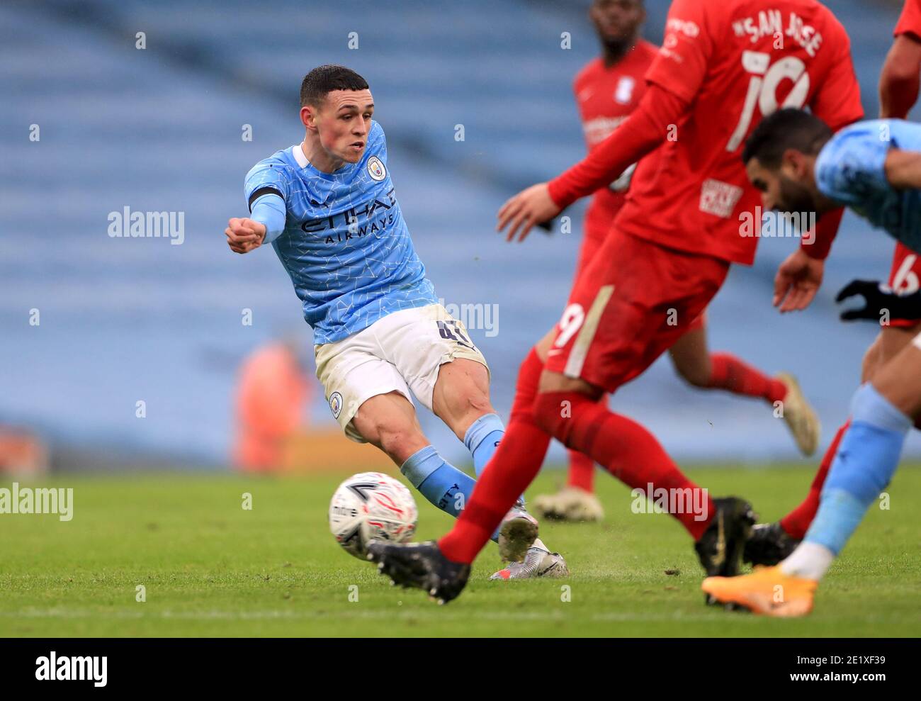 Manchester City's Phil Foden (left) scores his side's third goal of the ...