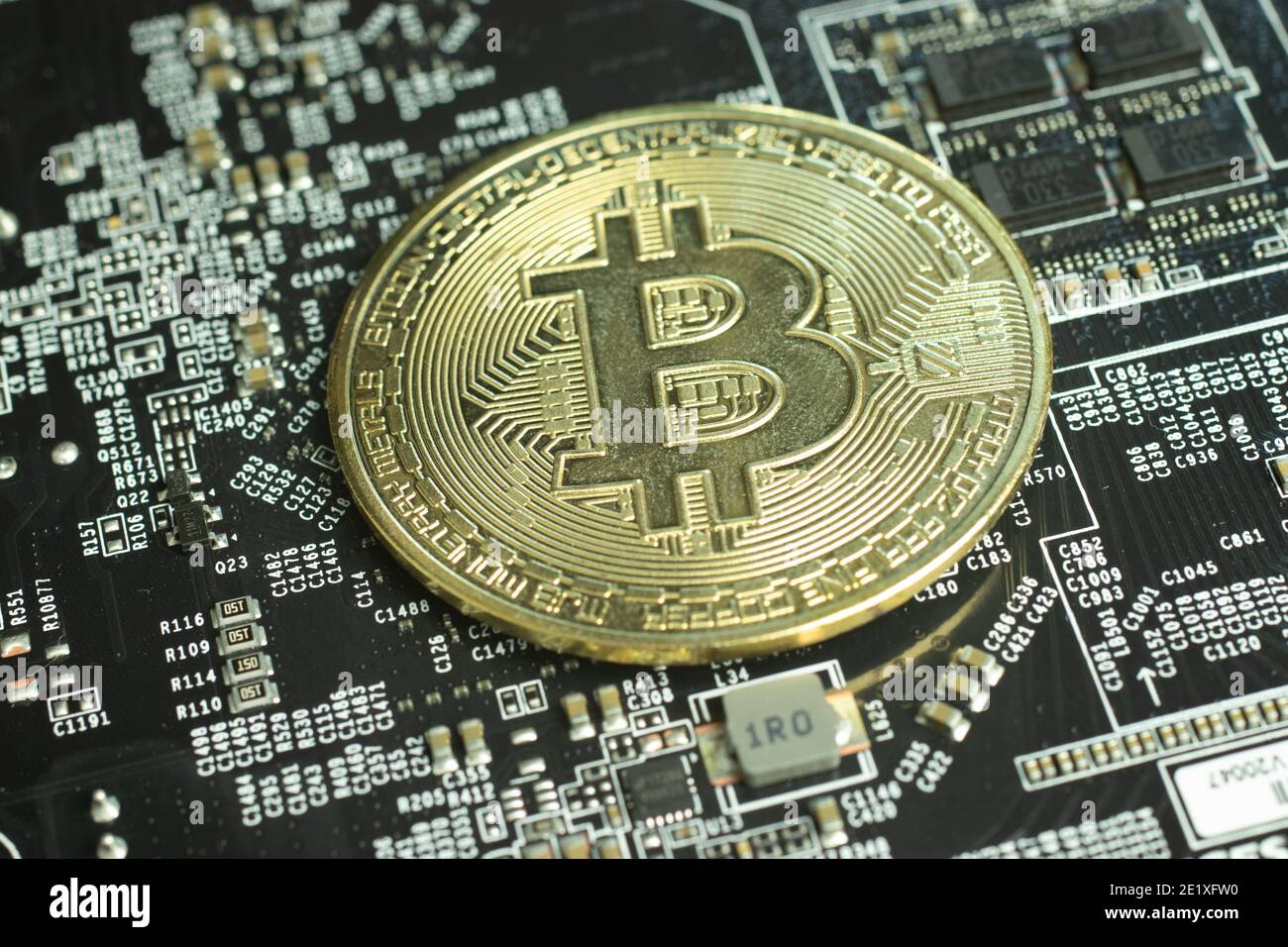 Bitcoin cryptocurrency on motherboard electronic circuit close up ...