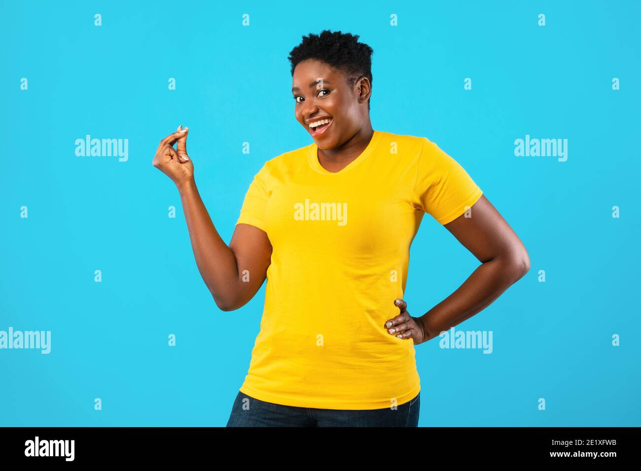 African Oversized Woman Clicking Fingers Standing Posing On Blue ...