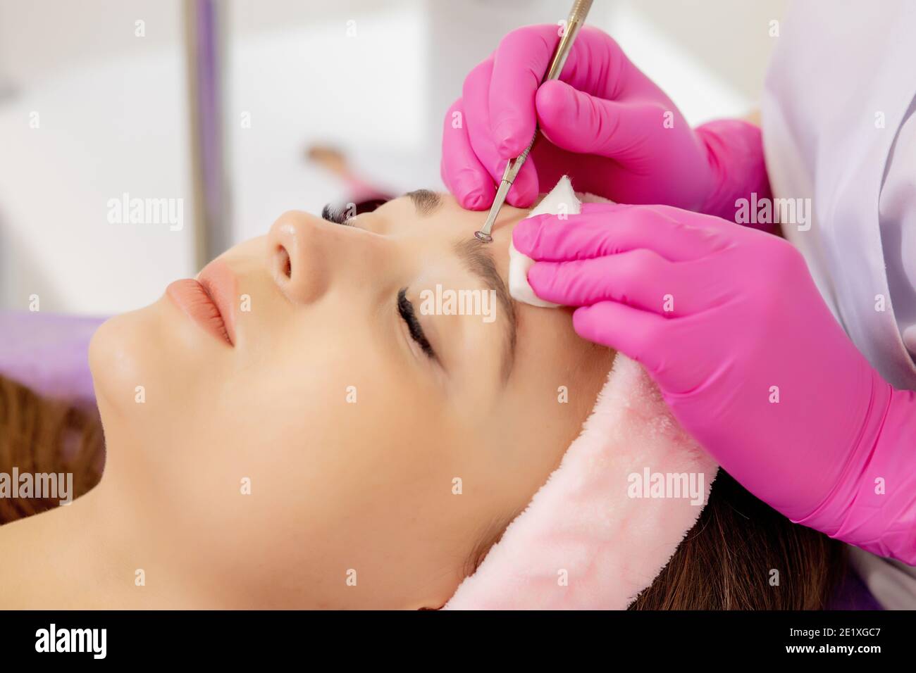 Cosmetologist at spa beauty salon doing acne treatment using mechanical ...